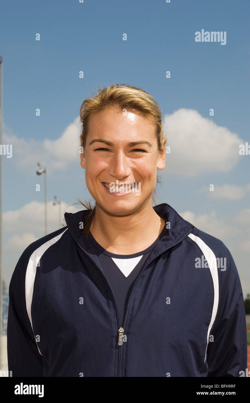 Female track athlete standing on track, portrait Stock Photo - Alamy