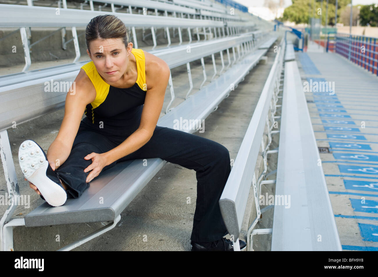 Female track athlete stretching Stock Photo - Alamy