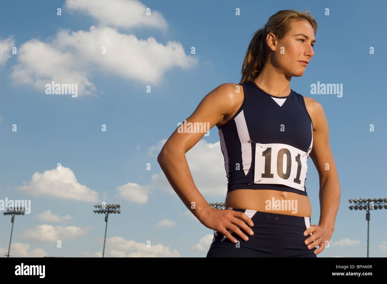 Female track athlete standing on track Stock Photo - Alamy