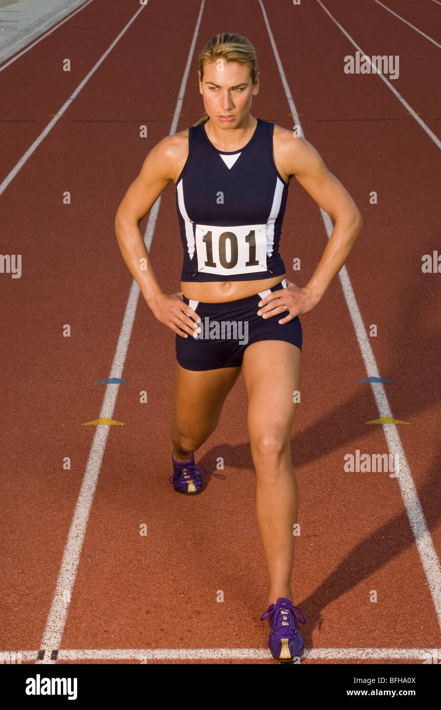 Female track athlete stretching Stock Photo - Alamy