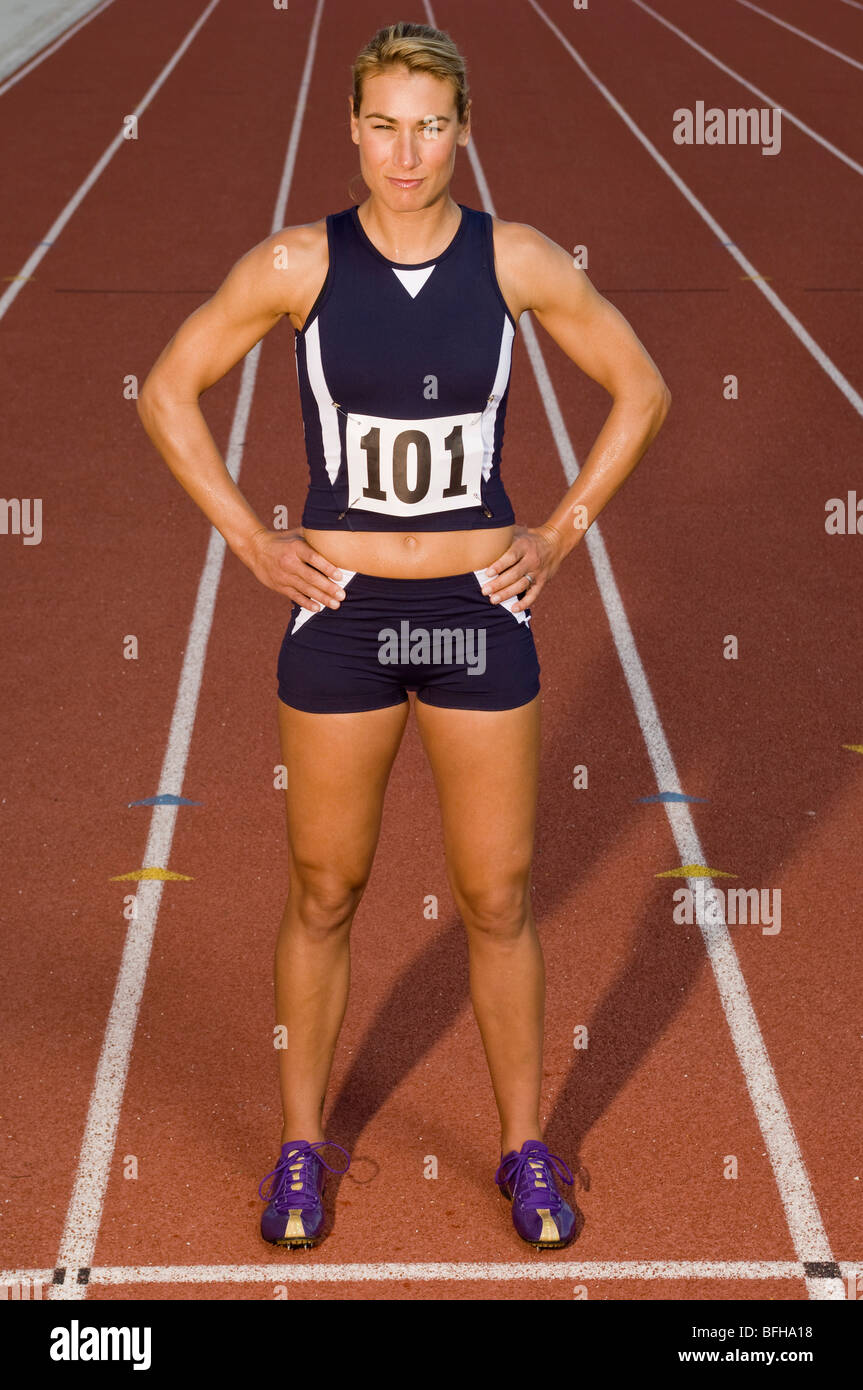 Female track athlete standing on track Stock Photo - Alamy