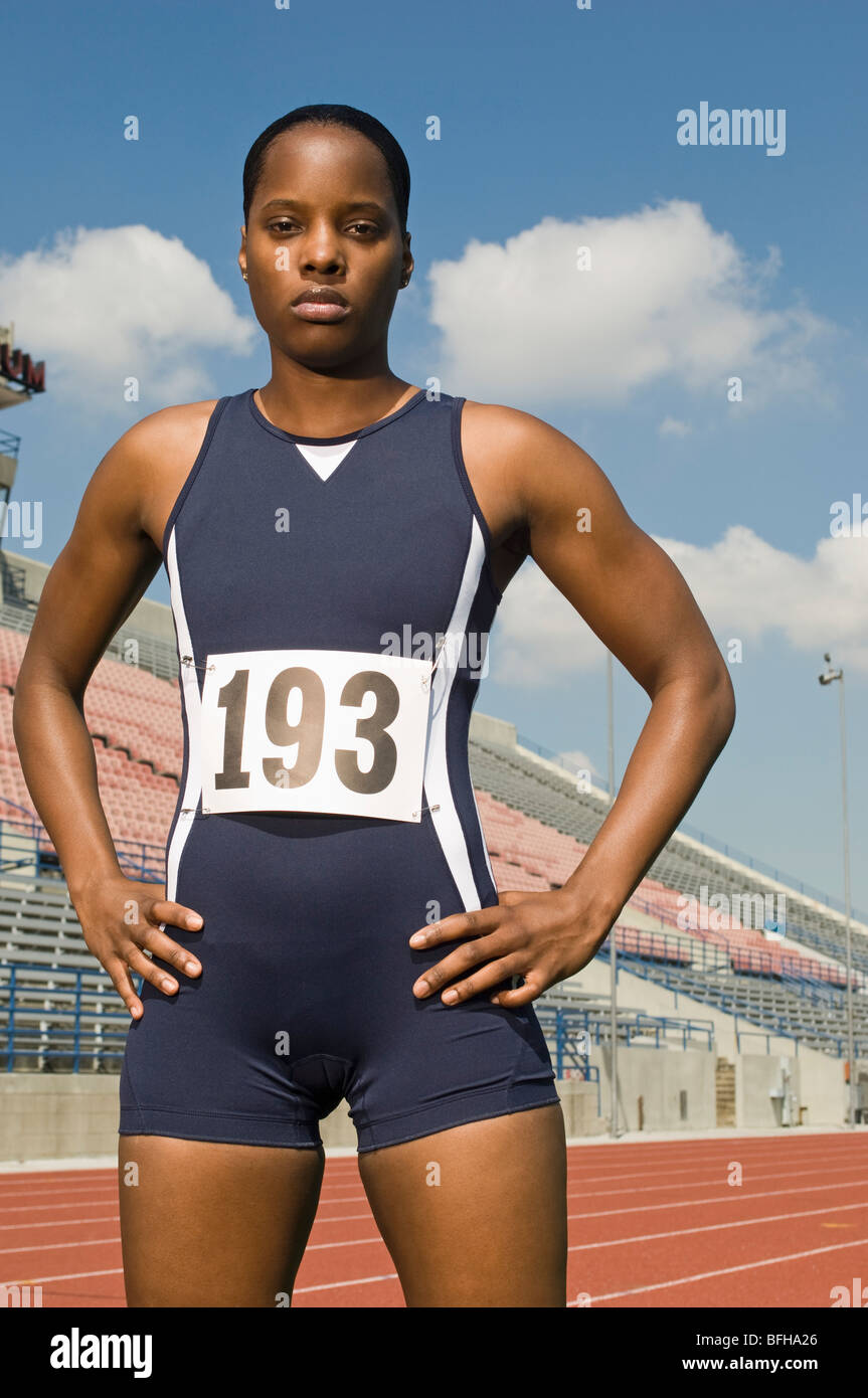 Female track athlete standing on track Stock Photo - Alamy