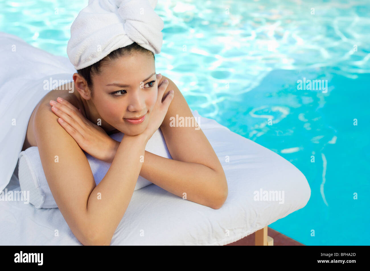 Young Chinese woman lying by swimming pool Stock Photo - Alamy