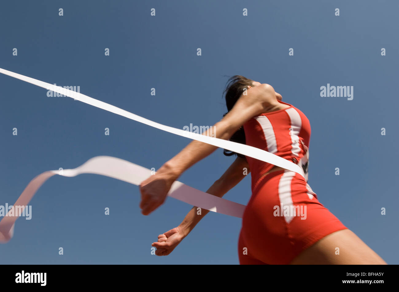Female track athlete crossing finishing line Stock Photo - Alamy