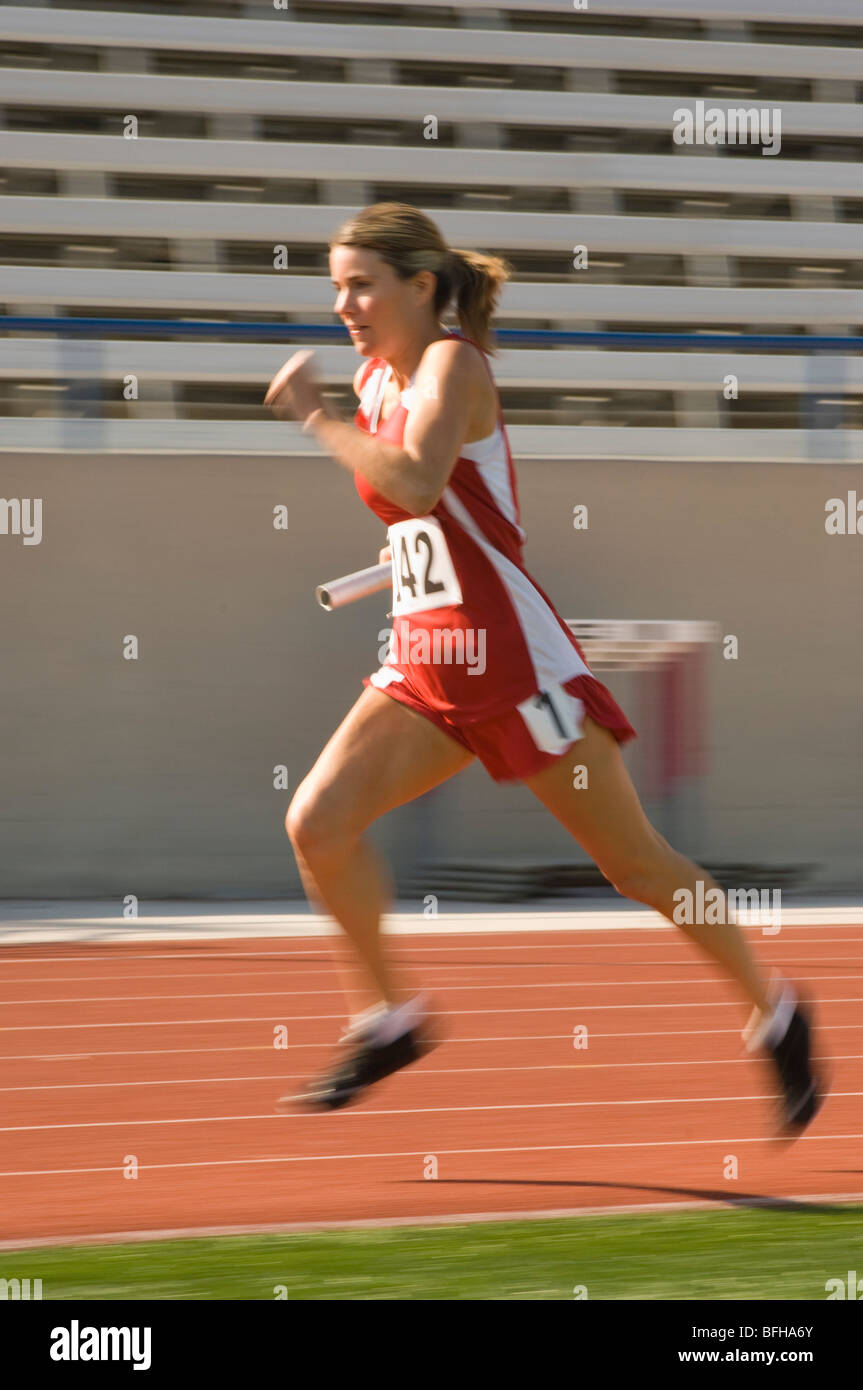 Female track athlete sprinting Stock Photo - Alamy