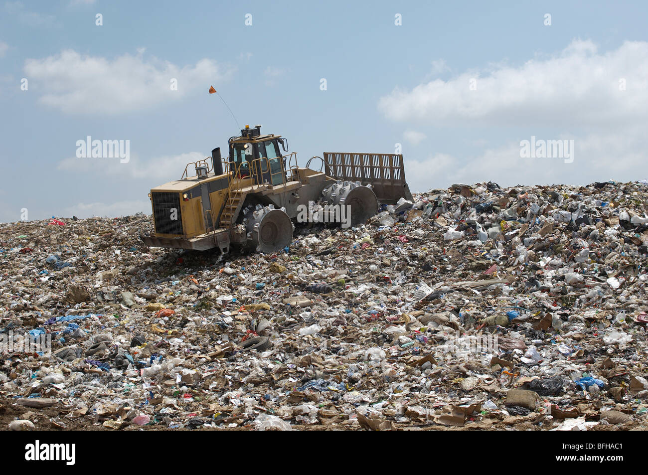 Digger working at landfill site Stock Photo - Alamy