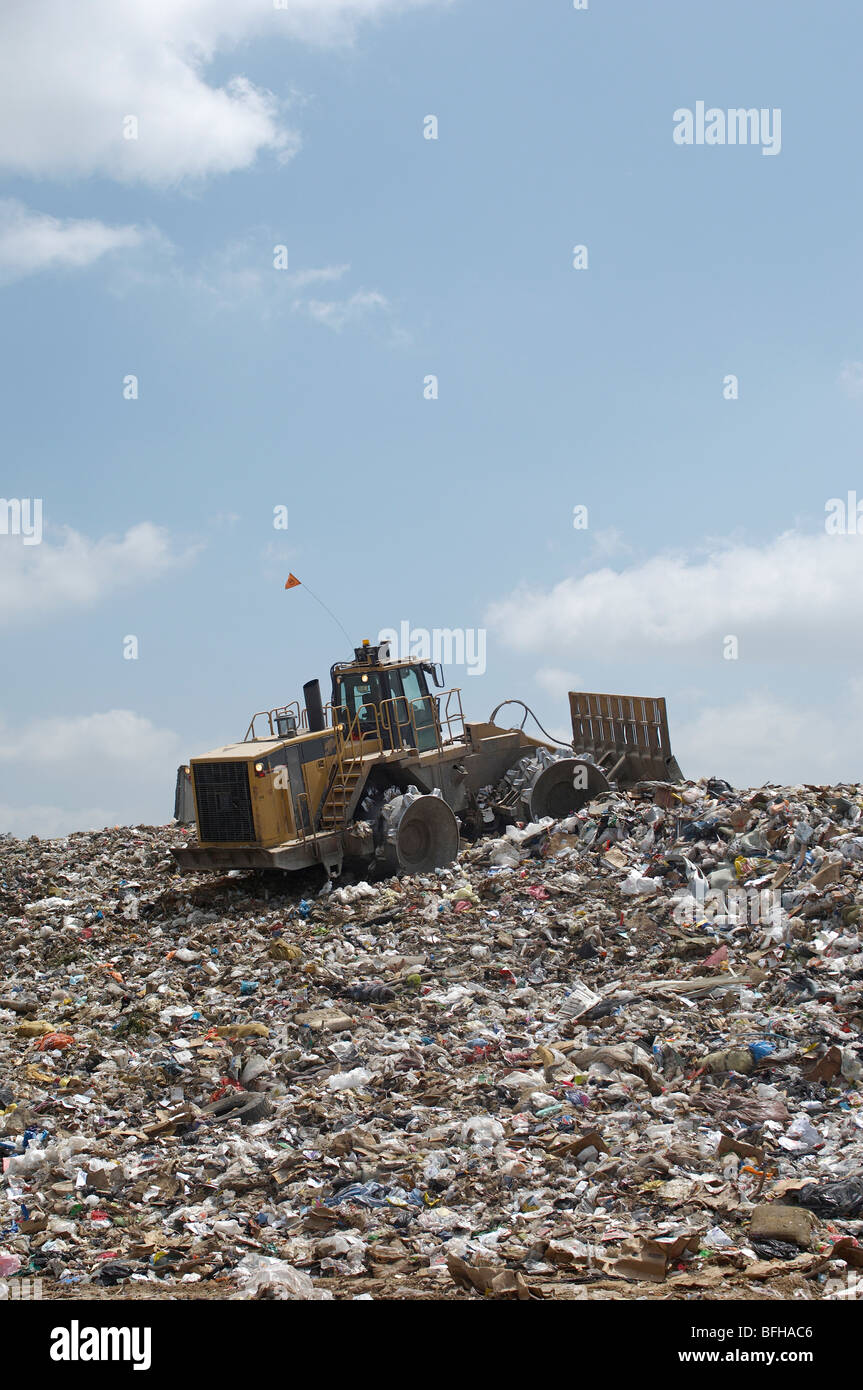 Digger working at landfill site Stock Photo - Alamy