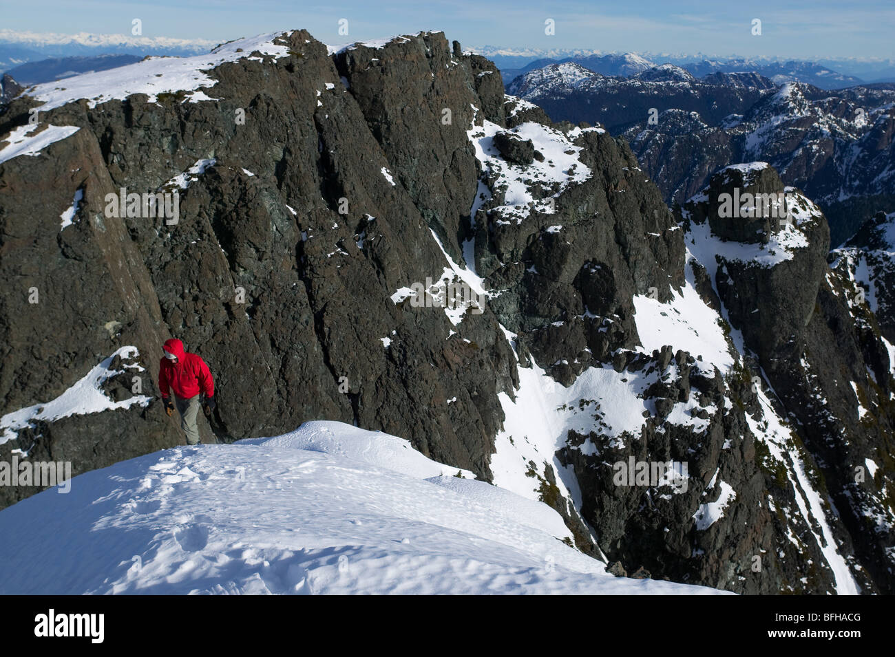 Lone climber ascends to summit snowfield of Mt. Cain looking South ...