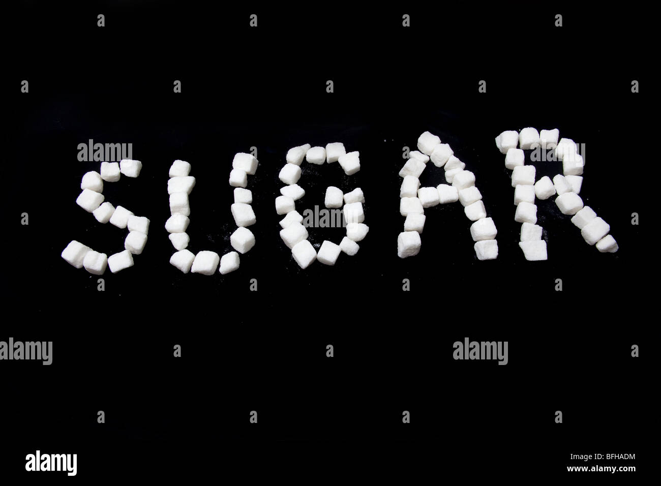 Sugar written in sugar lumps on a black studio background Stock Photo ...