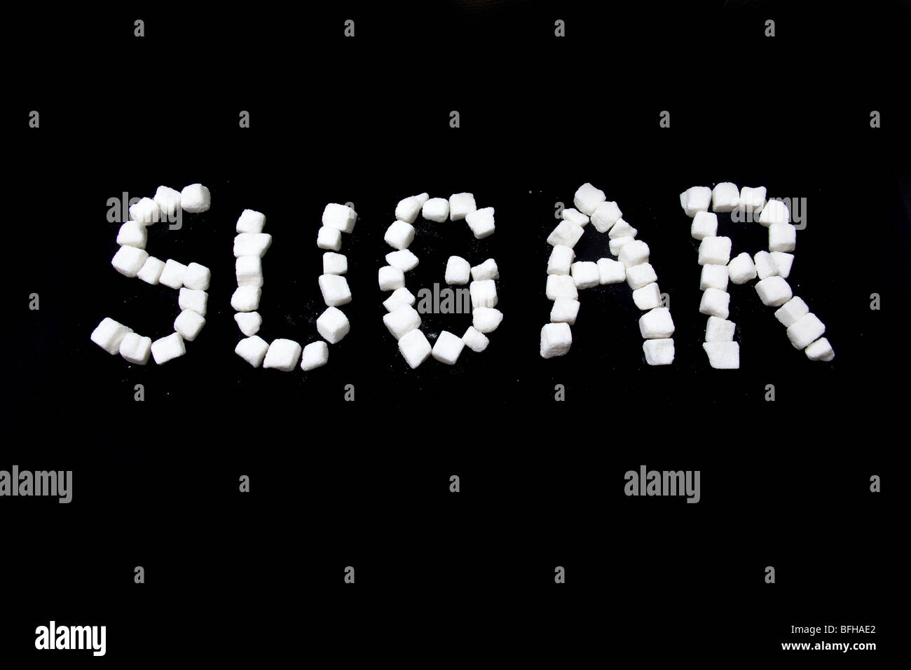 Sugar written in sugar lumps on a black studio background Stock Photo ...