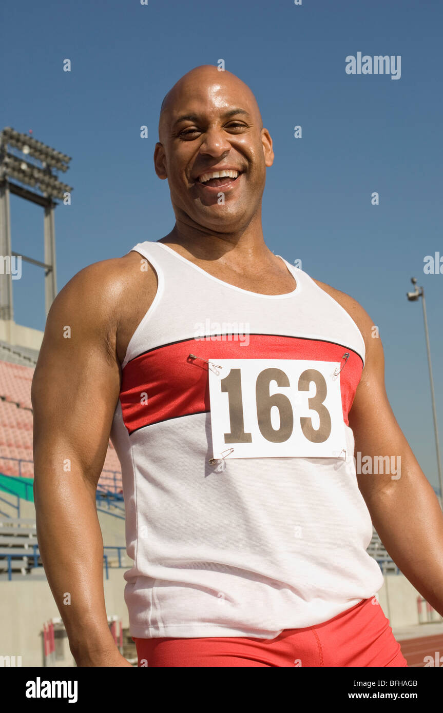 Portrait of laughing runner on a track Stock Photo - Alamy