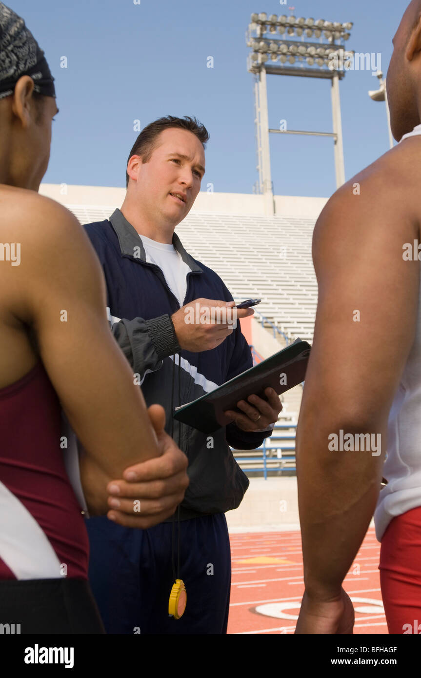 Trainer instructing runners Stock Photo - Alamy Trainer instructing runners Stock Photo - Alamy