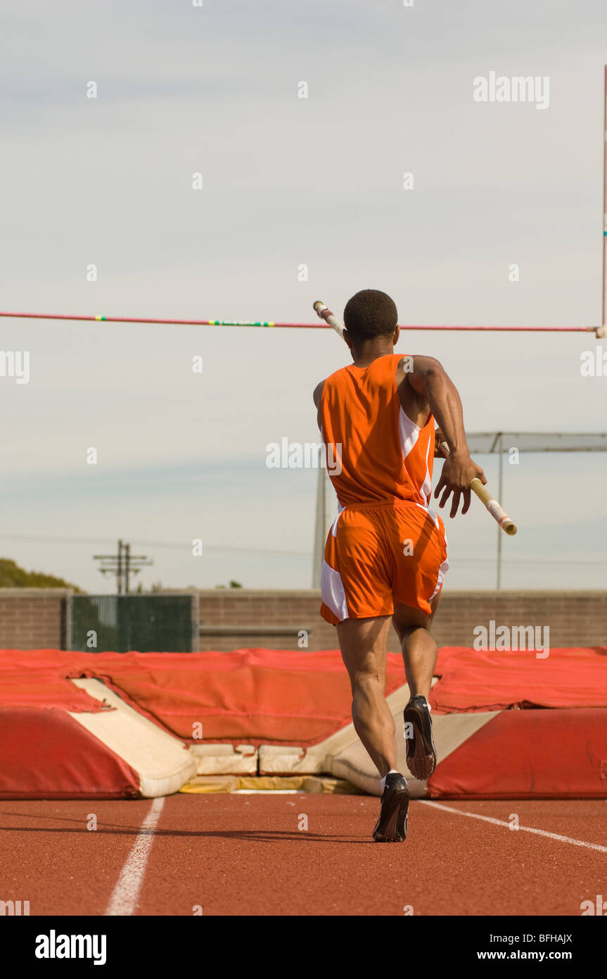 Pole-vaulter running with pole Stock Photo - Alamy