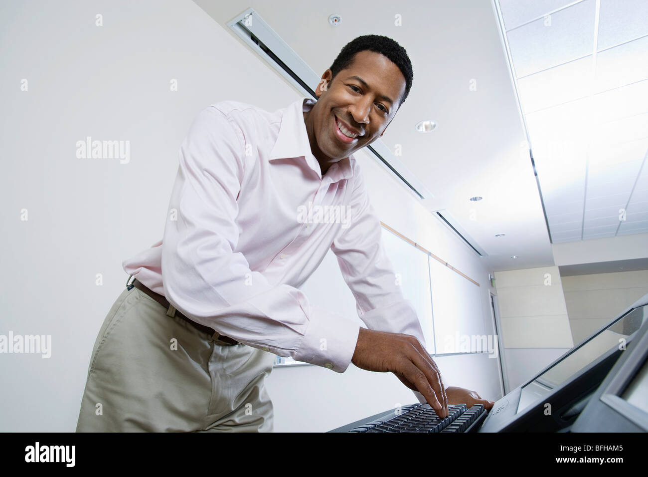Male lecturer using computer Stock Photo - Alamy