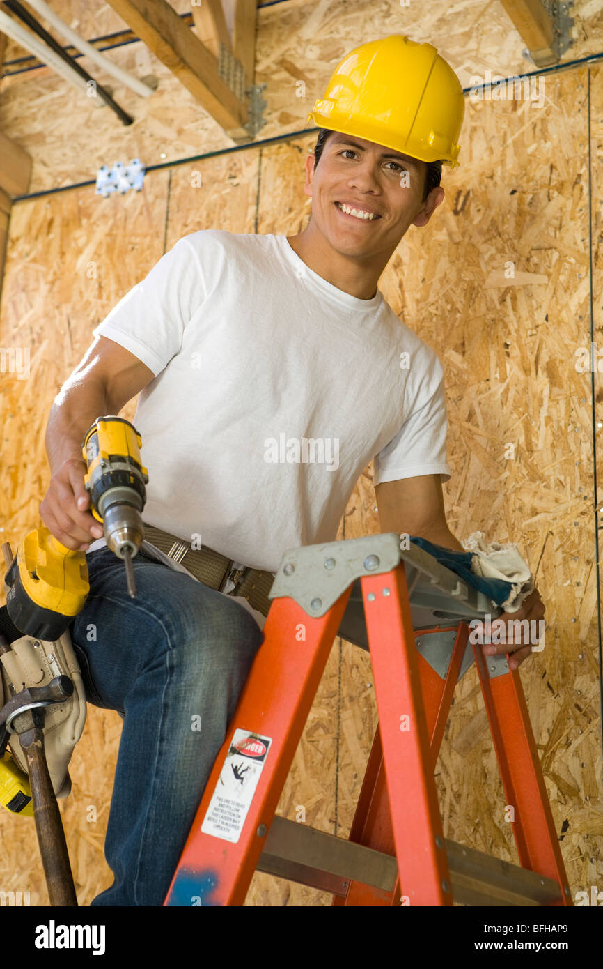 Construction worker on ladder, portrait Stock Photo - Alamy