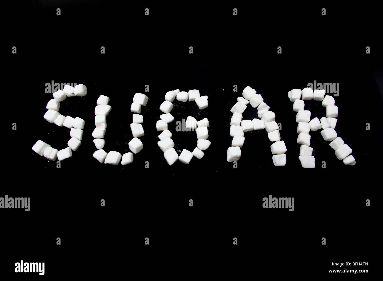 Sugar written in sugar lumps on a black studio background Stock Photo ...