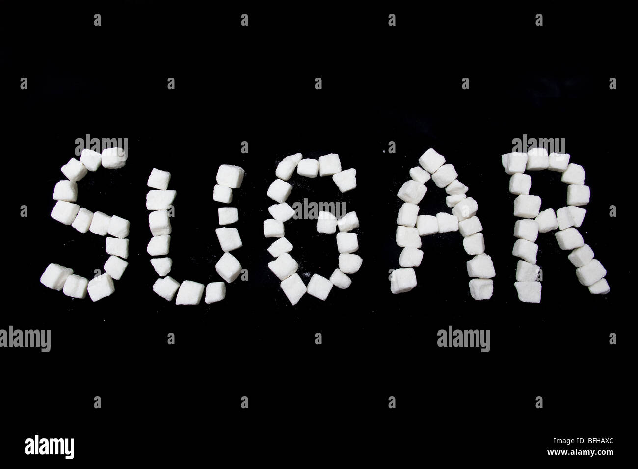 Sugar written in sugar lumps on a black studio background Stock Photo ...