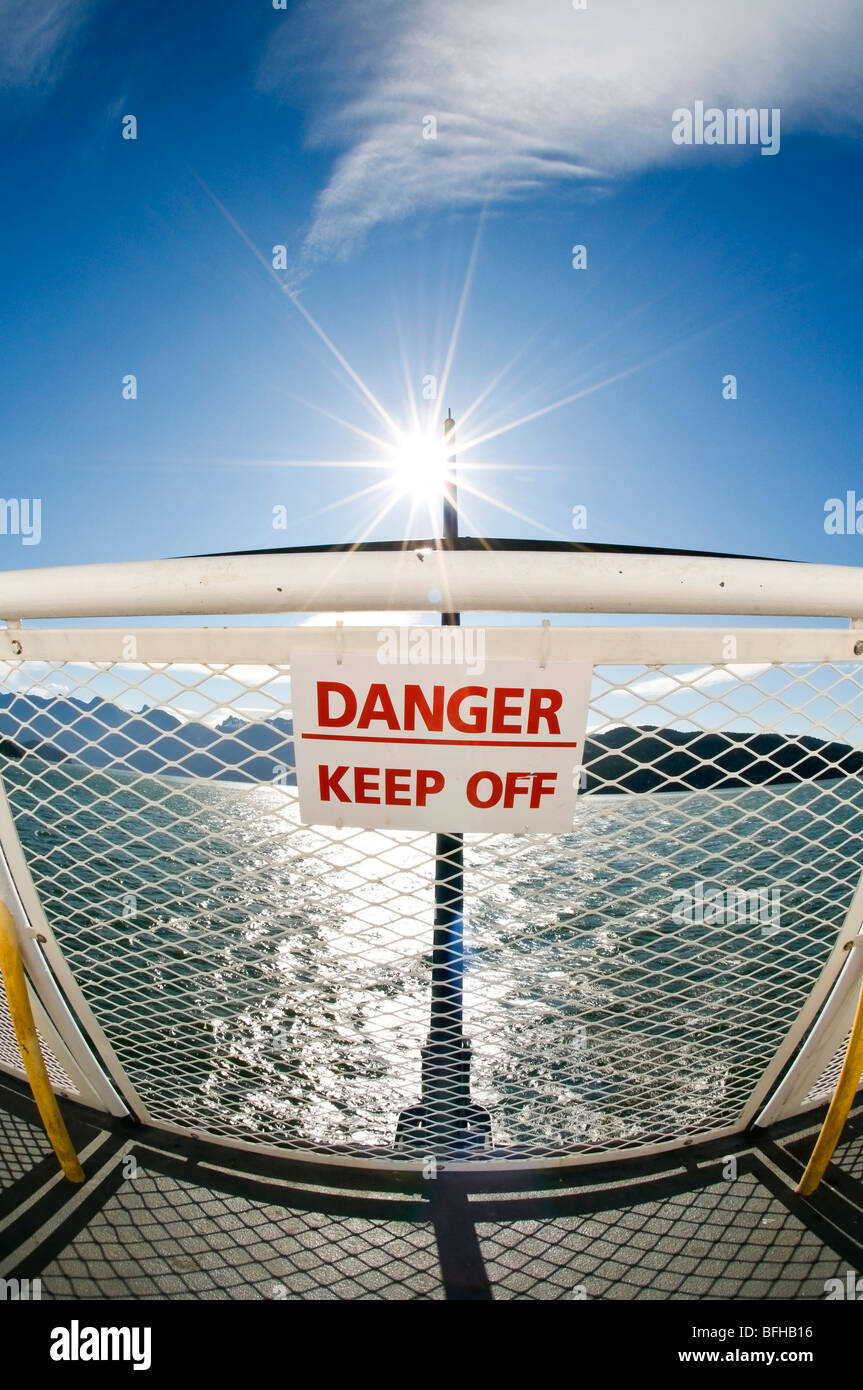 A sign on a ferry railing states 'Danger - Keep Off' Stock Photo - Alamy