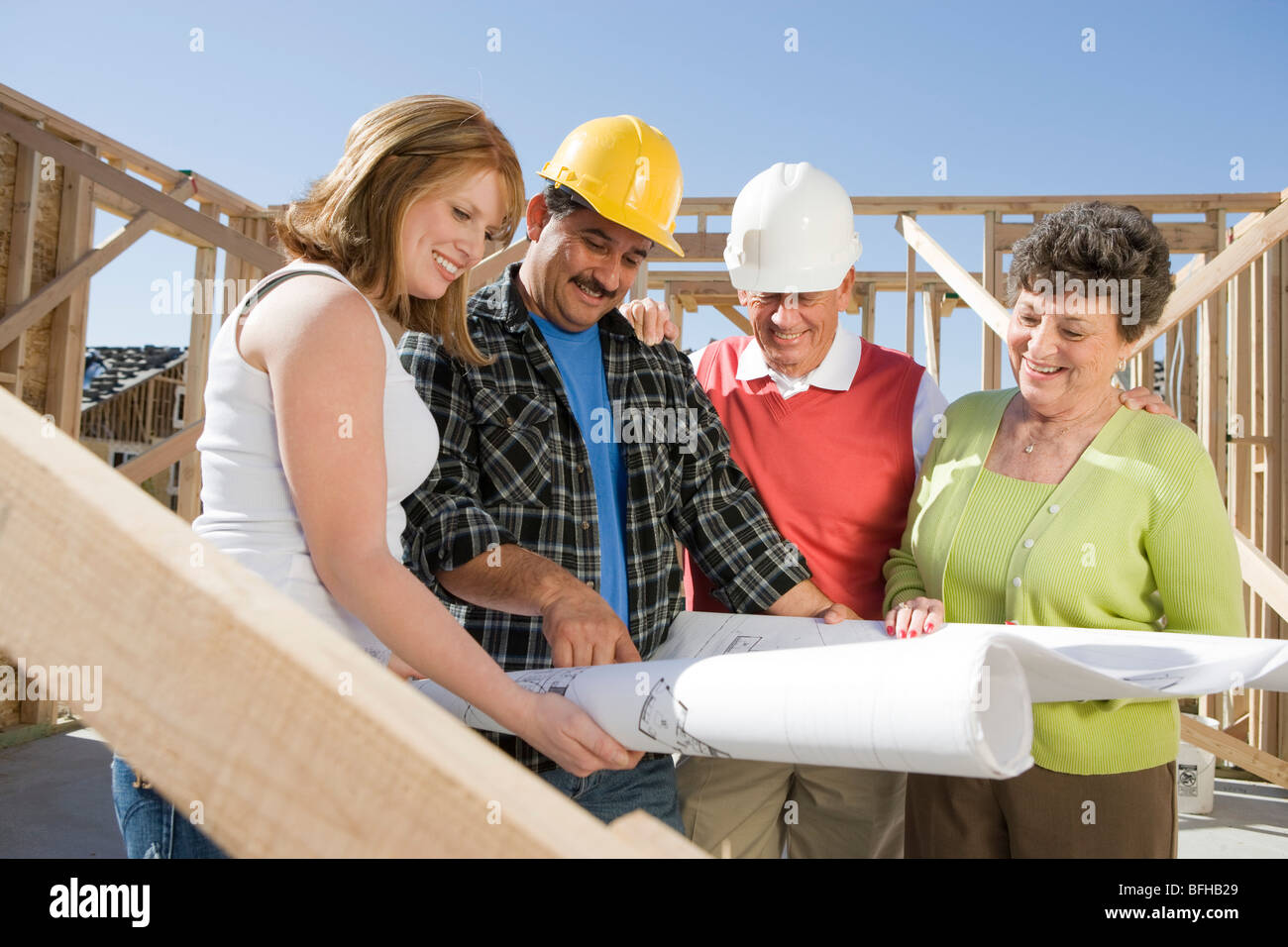 Construction workers observing plans on construction site Stock Photo ...