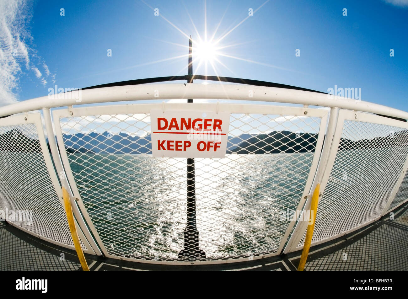 A sign on a ferry railing states 'Danger - Keep Off' Stock Photo - Alamy