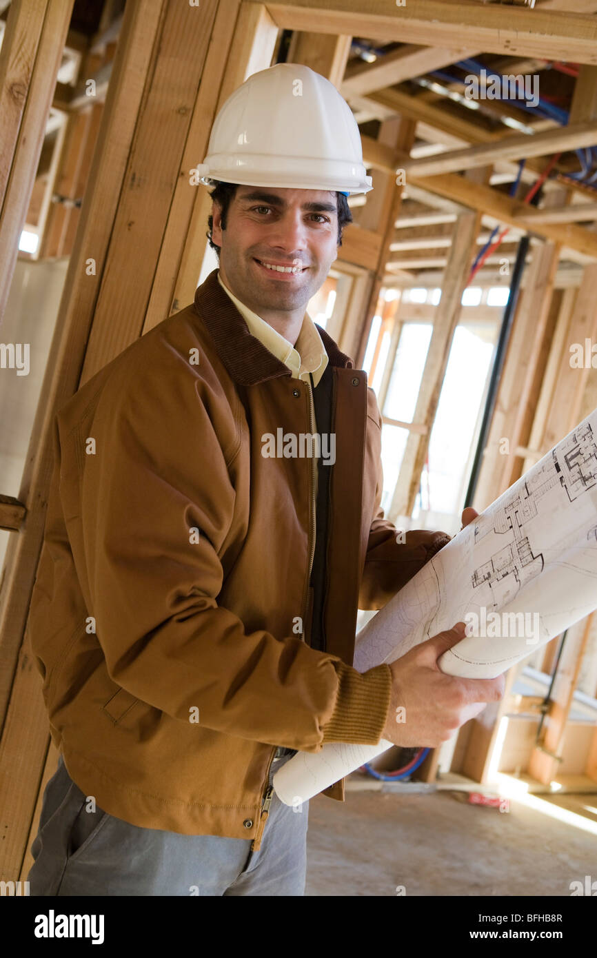 Man holding blueprint in construction site Stock Photo - Alamy