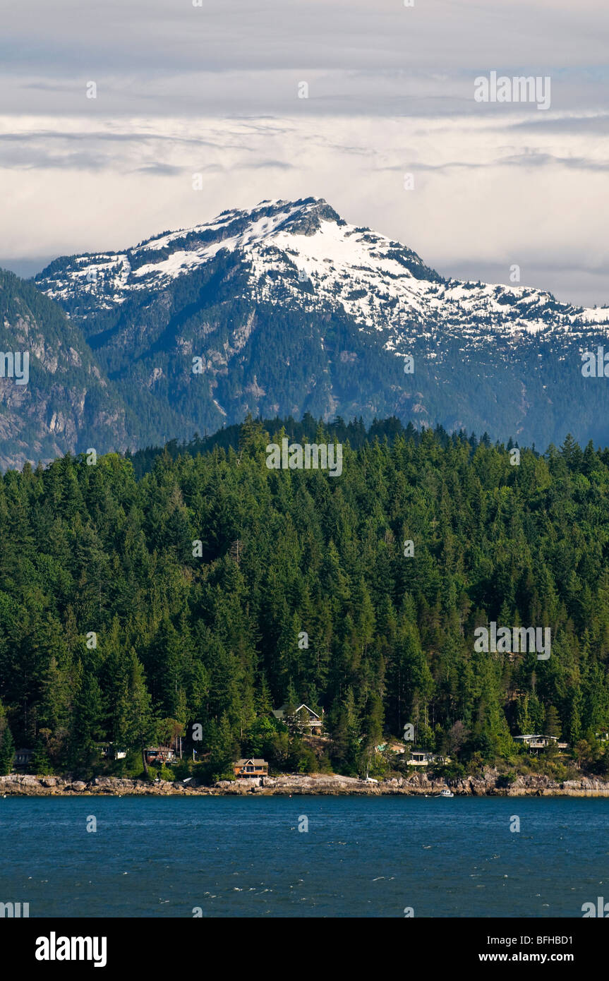 Homes sit along the water in Howe Sound, with BC's Coast Mountains ...