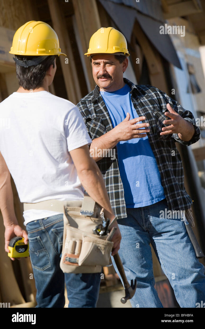 Workers in construction site Stock Photo - Alamy