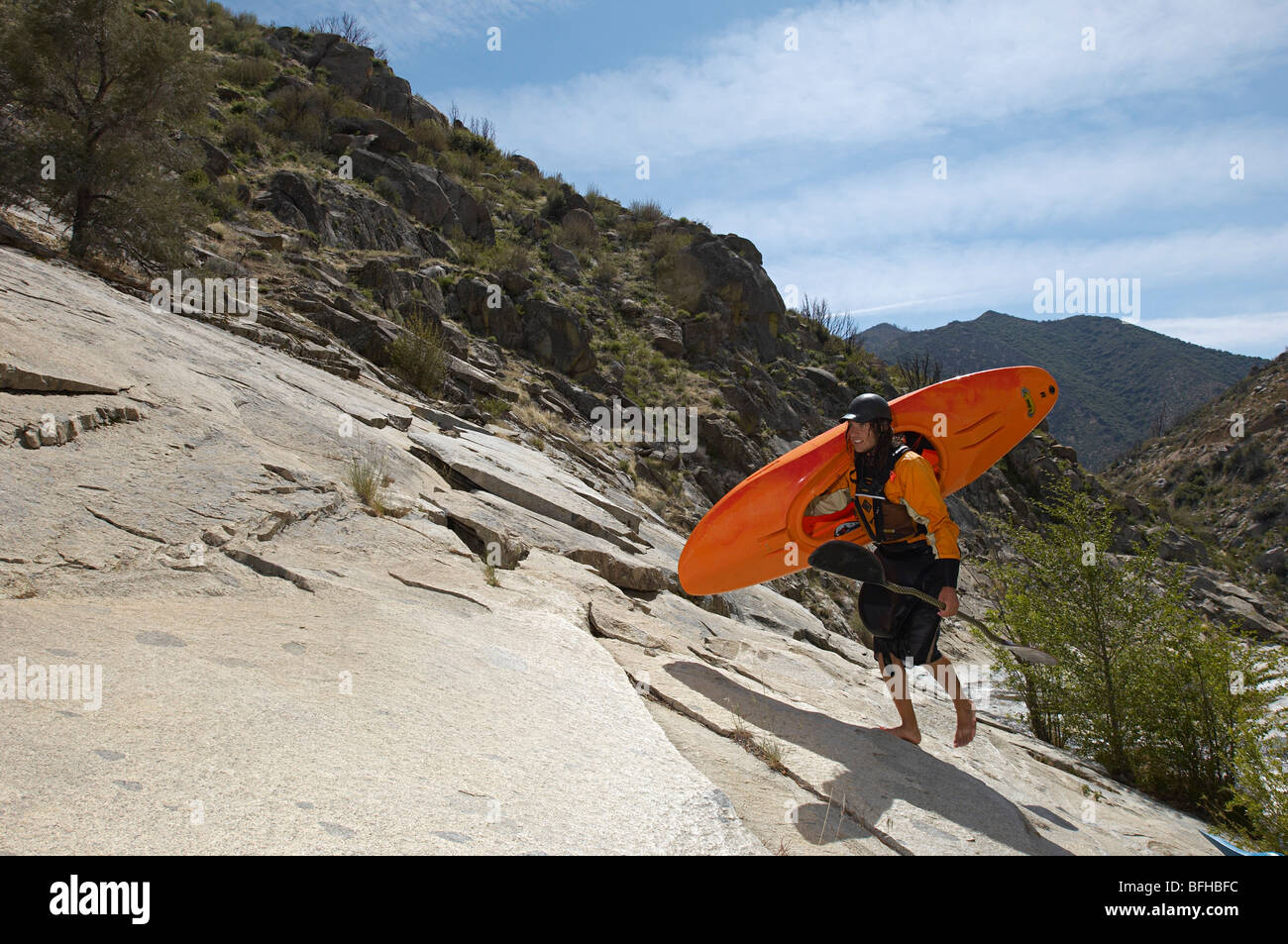 Female kayaker walking on rock, side view Stock Photo - Alamy