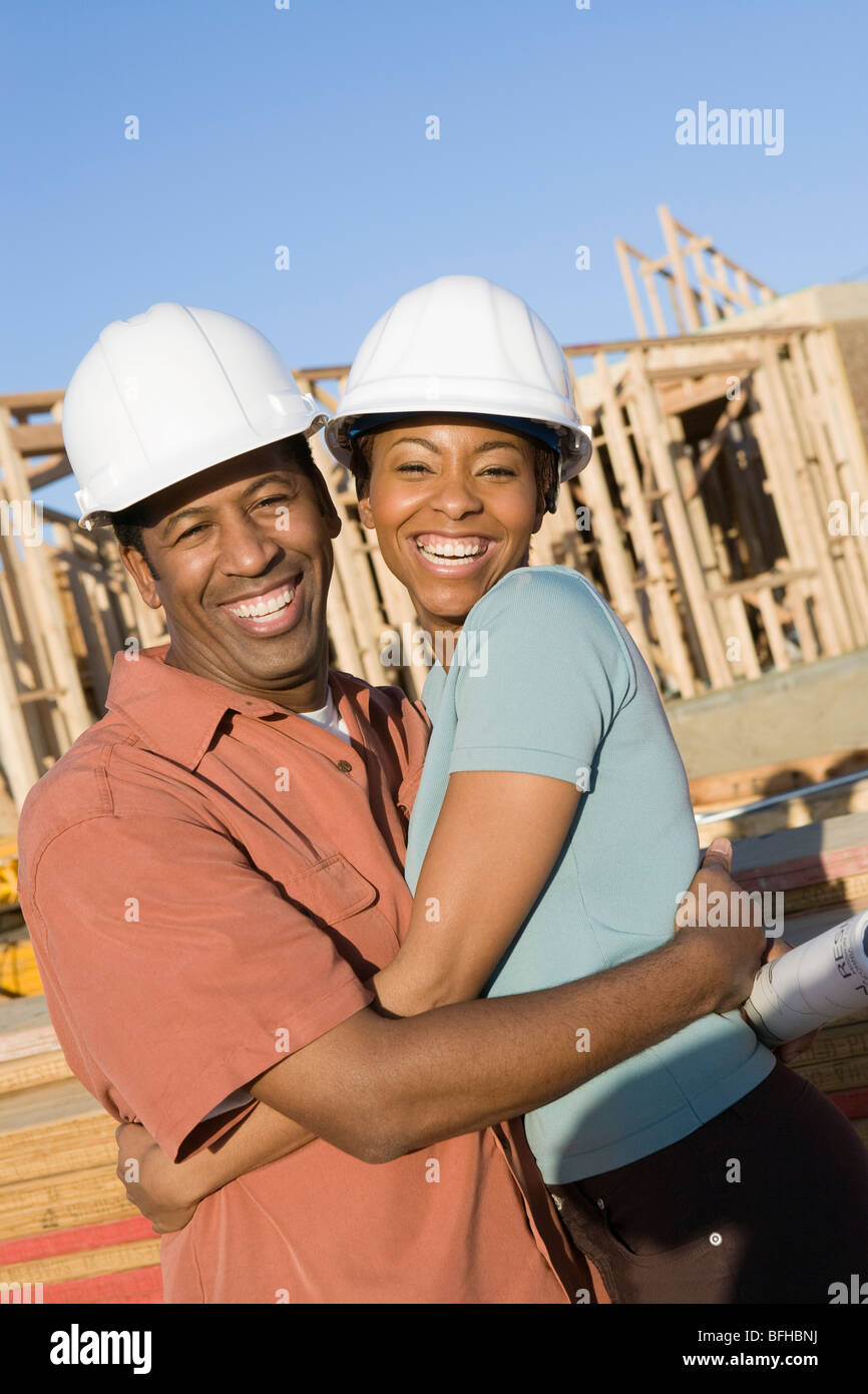 Enthusiastic couple in construction site Stock Photo - Alamy