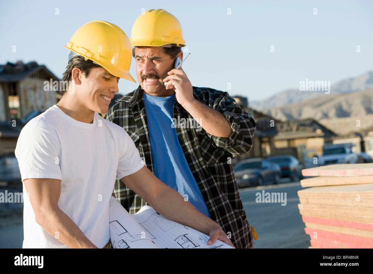 Construction workers using mobile hi-res stock photography and images ...
