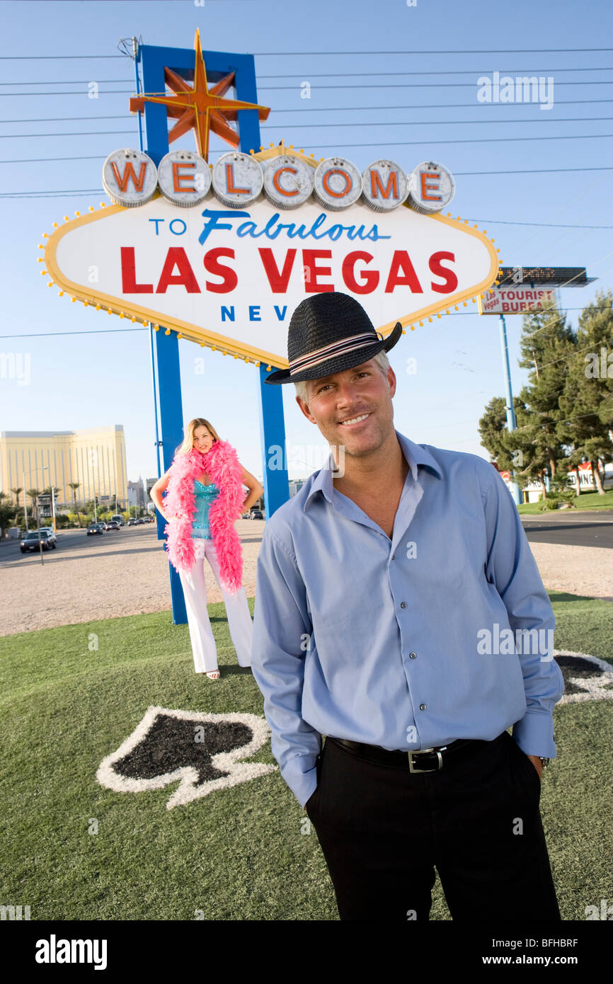 Portrait of mid-adult man in front of Welcome to Las Vegas sign, mid ...