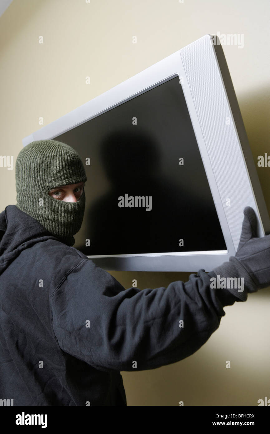 Thief stealing flat screen television Stock Photo - Alamy