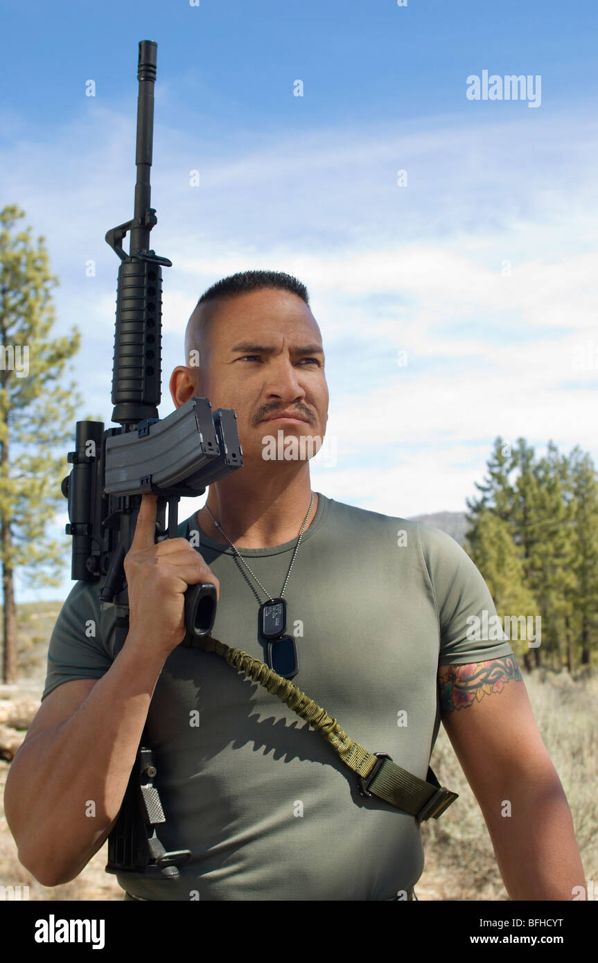 Portrait of soldier with machine gun Stock Photo - Alamy