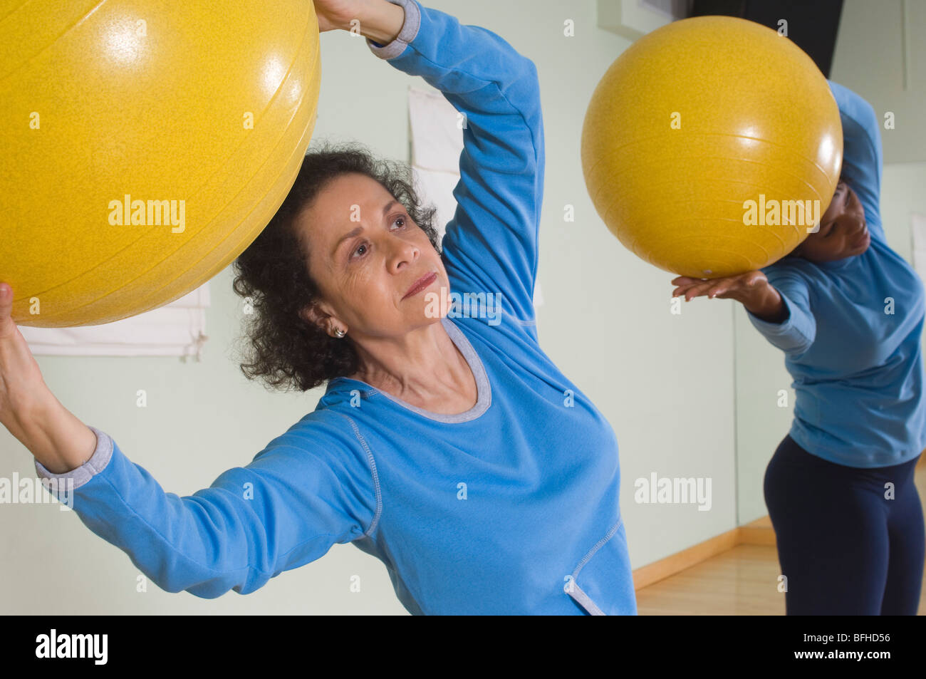 Senior Woman Using Exercise Ball in Fitness Class Stock Photo - Alamy
