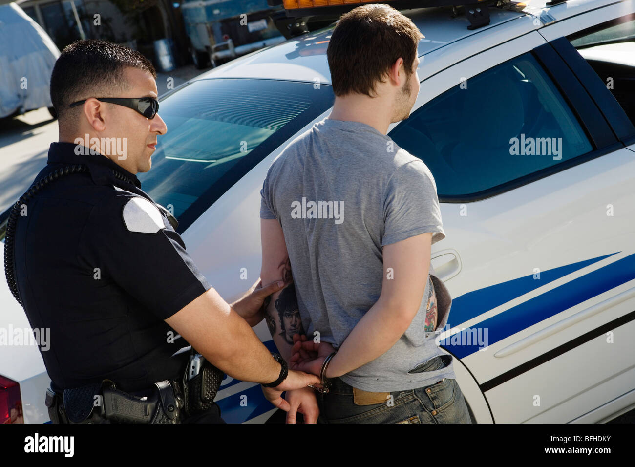 Police Officer Arresting Young Man Stock Photo - Alamy