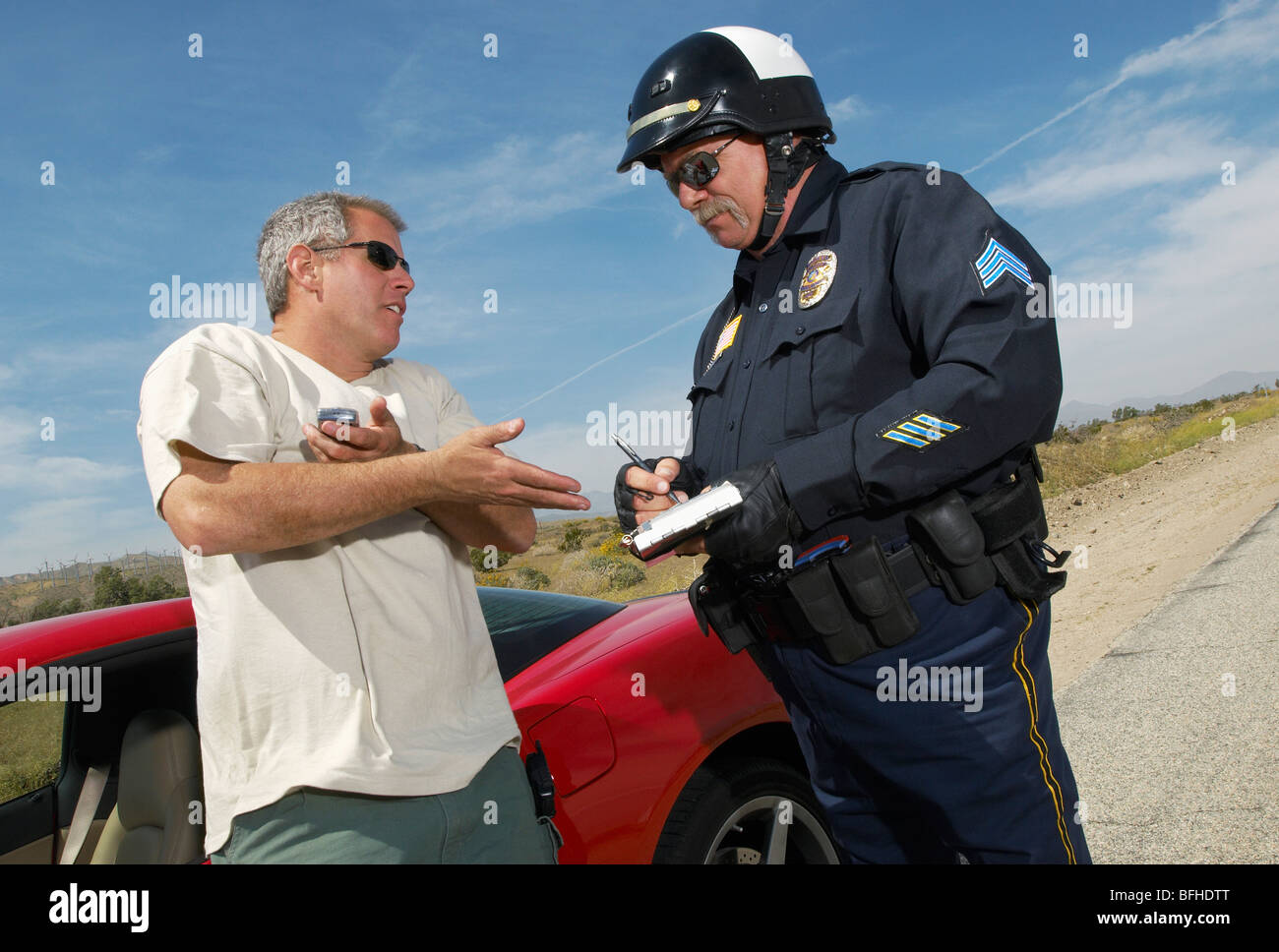 Traffic cop talking with driver of sports car Stock Photo - Alamy