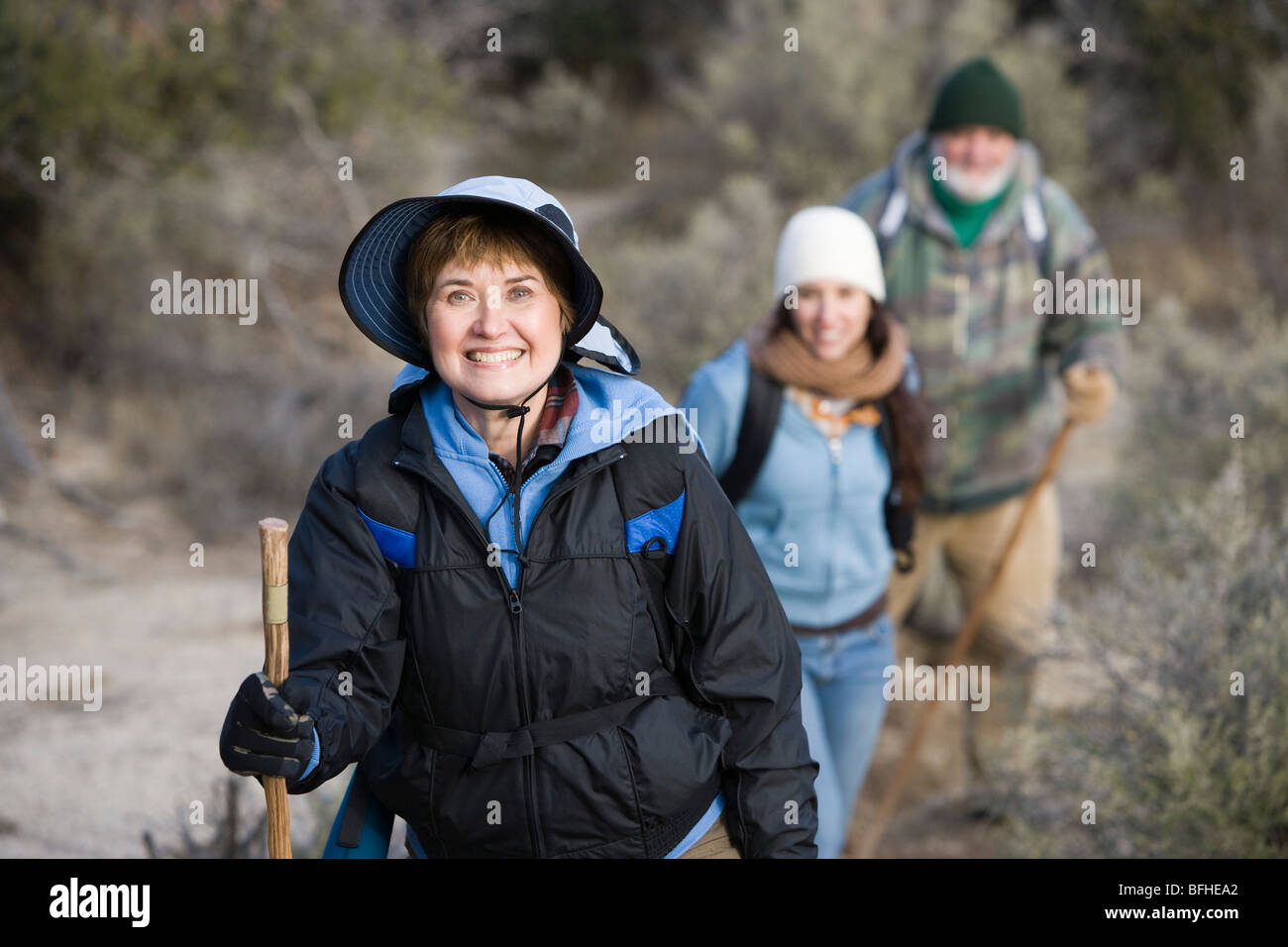 Three hikers on trail Stock Photo - Alamy