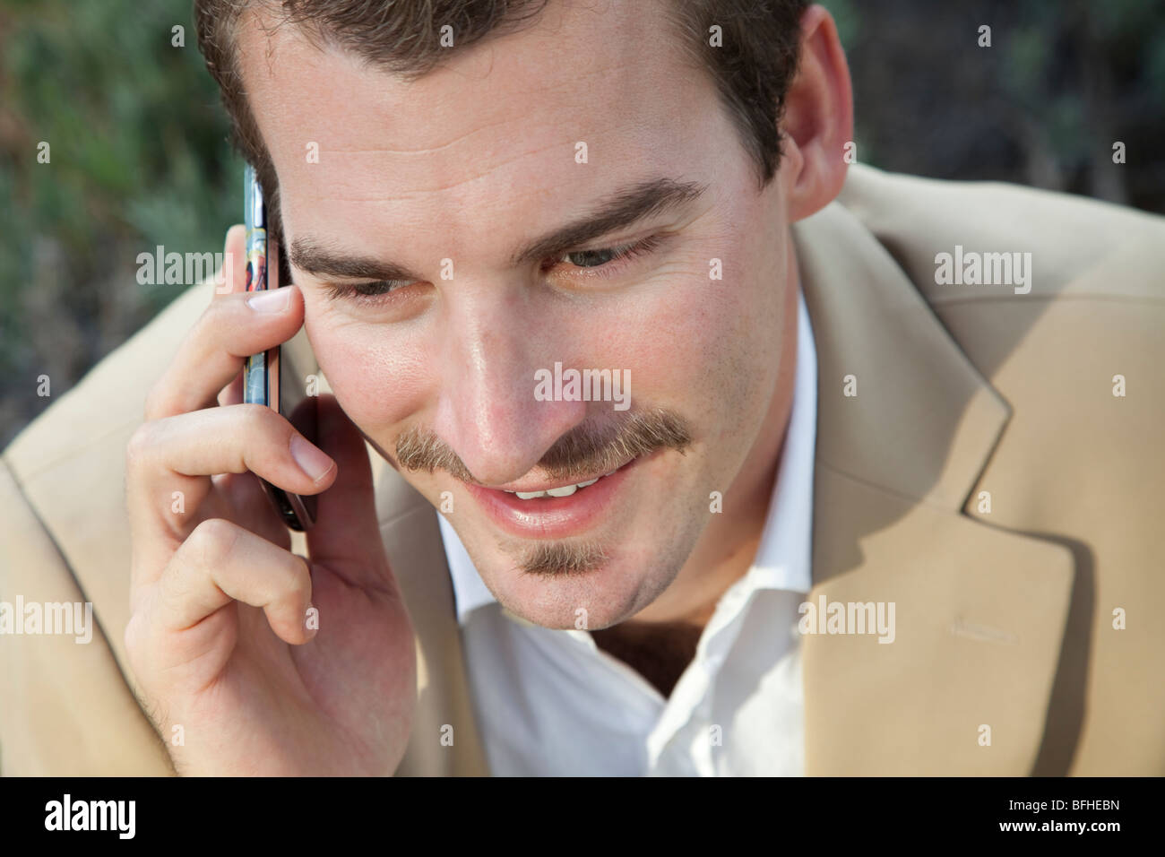 close up on a trendy young man using his phone Stock Photo - Alamy