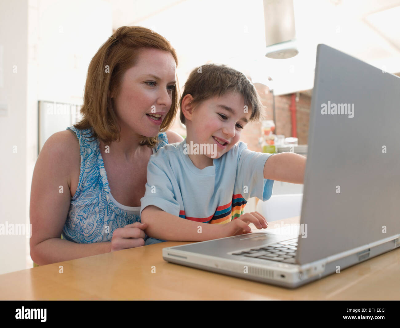 Mother Helping Son Use Laptop Stock Photo - Alamy