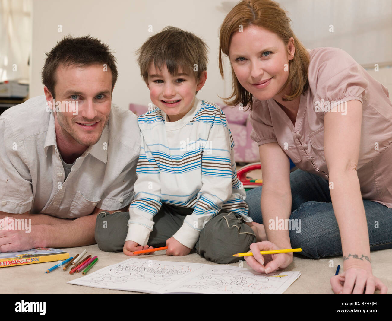 Parents on Floor Coloring With Son Stock Photo - Alamy