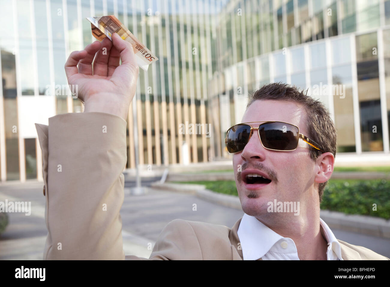 young businessman flying a money plane Stock Photo - Alamy