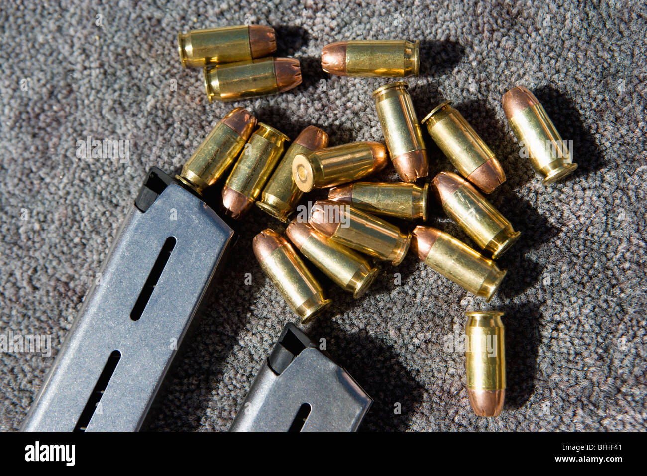 Gun magazine and bullets on carpet, close-up Stock Photo - Alamy