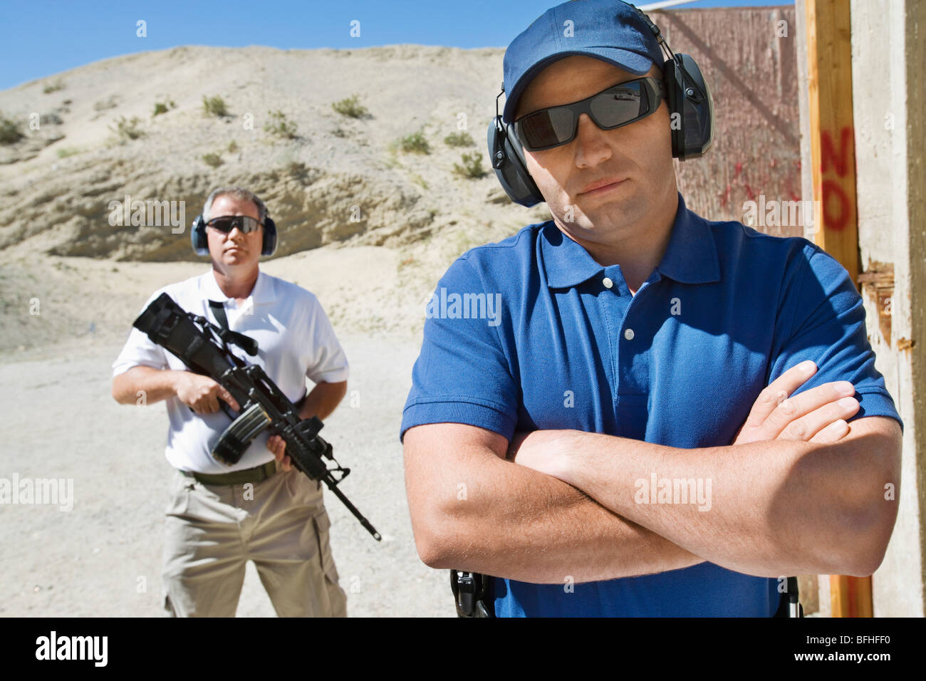 Two men at firing range in desert, portrait Stock Photo - Alamy