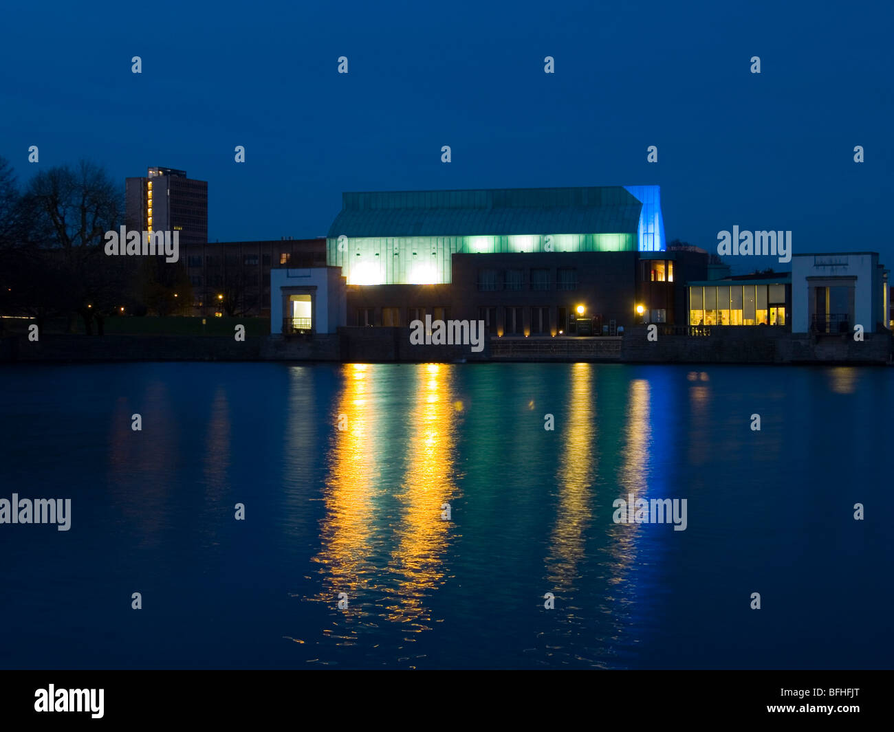 The Lakeside Arts Centre reflected in the lake at night at the ...