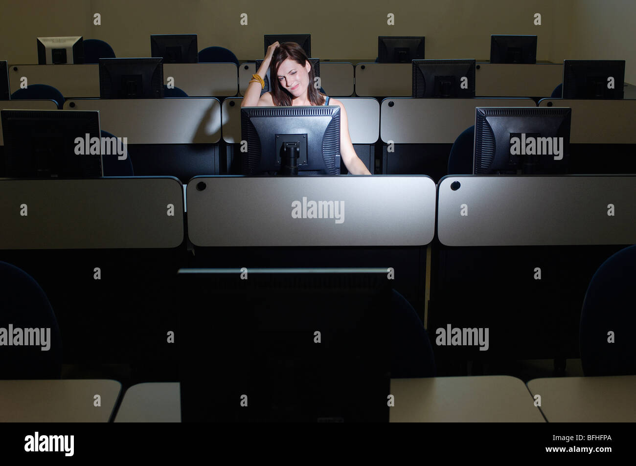 Female student with hand on head in computer classroom Stock Photo - Alamy