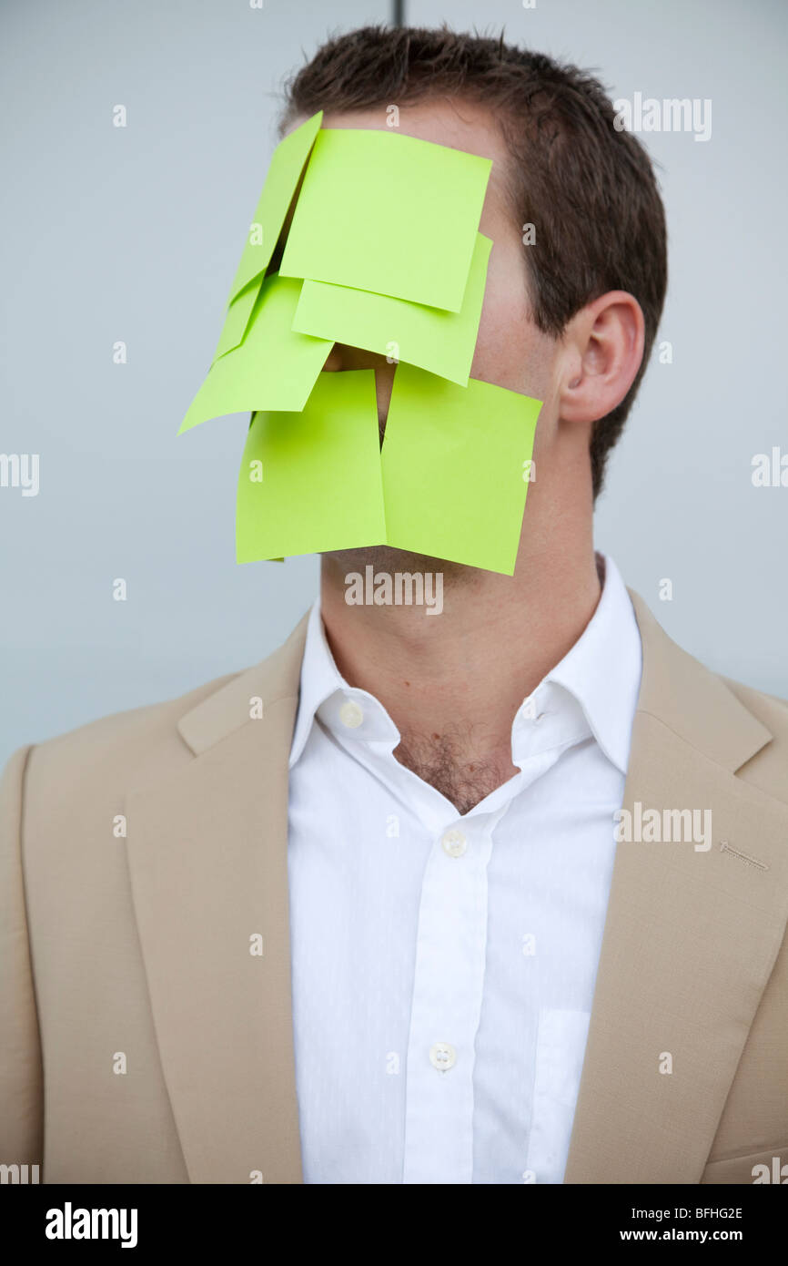 Portrait of a young mans face covered in sticky reminder notes Stock ...