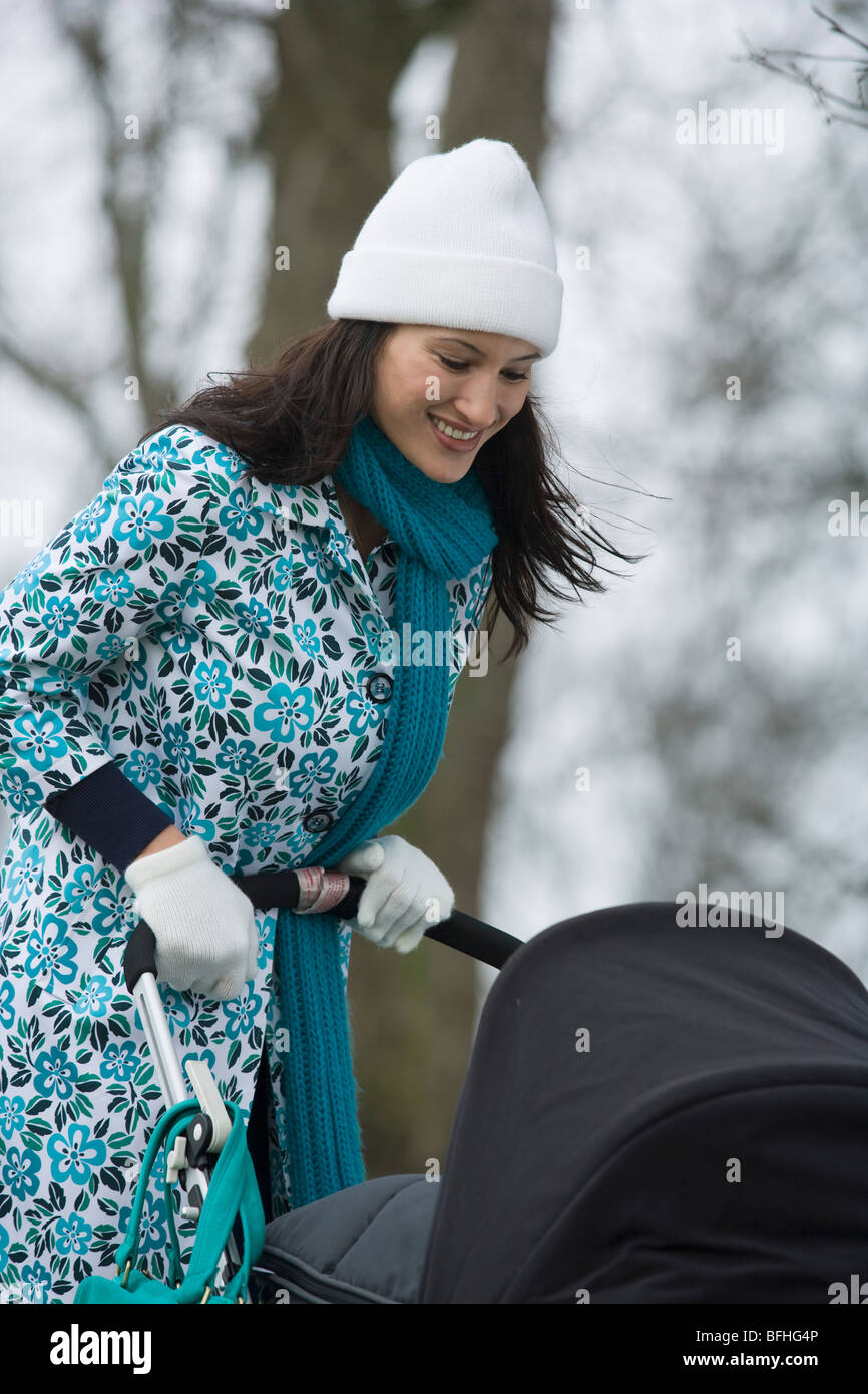 Mother pushing stroller in park Stock Photo - Alamy