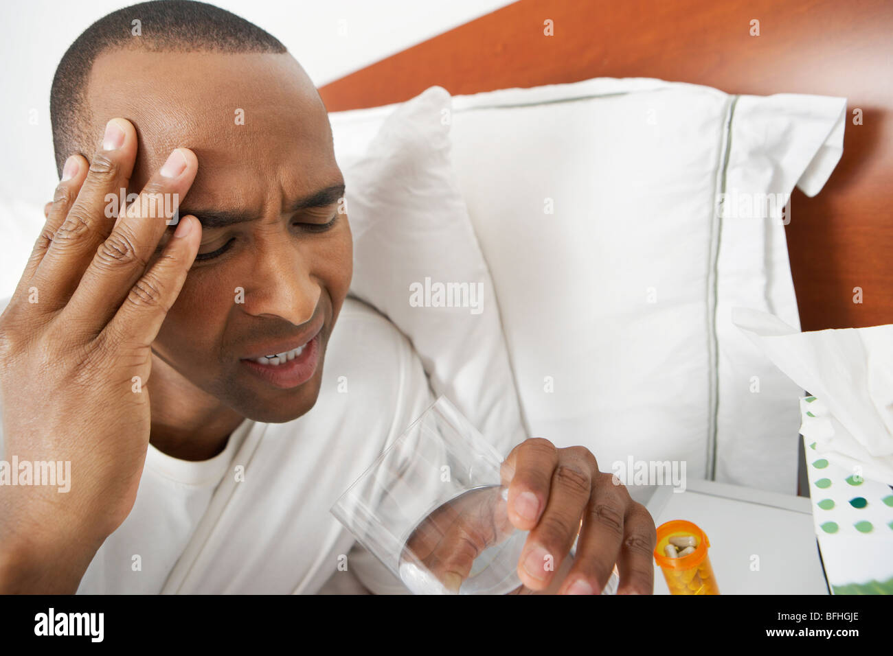 Man with headache in hospital bed Stock Photo - Alamy