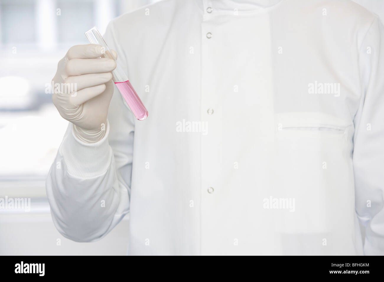 Scientist holding test tube sample, mid-section Stock Photo - Alamy