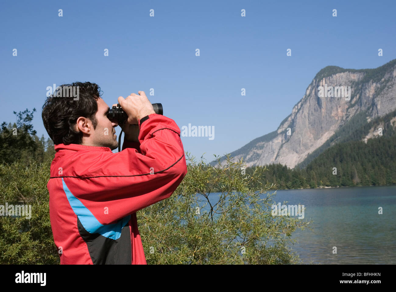 A man looking through a binocular - Lake Tovel - Adamello Brenta ...